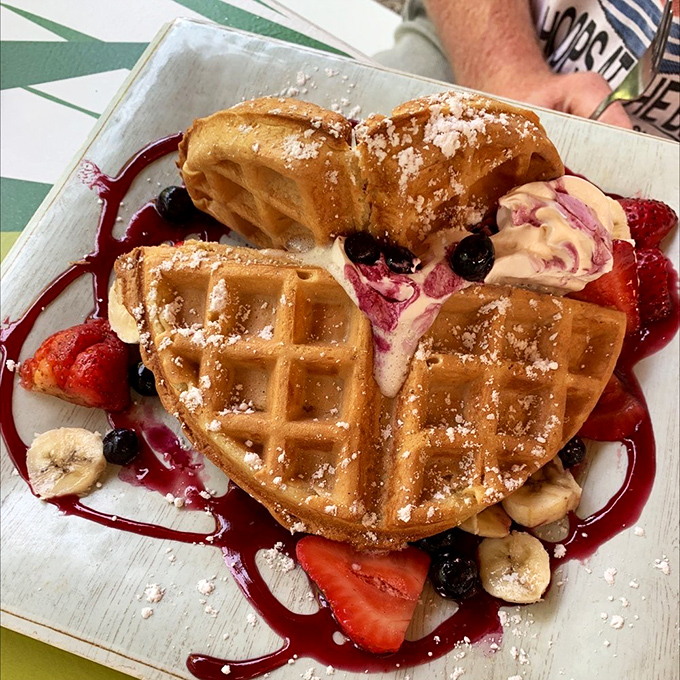 This Belgian waffle isn't just breakfast&mdash;it's art, with berries and bananas playing supporting roles to that perfect golden crunch.