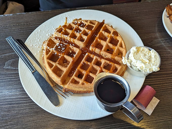 Golden waffle perfection that makes you question why anyone would ever choose a pancake. That butter scoop is practically begging to melt.