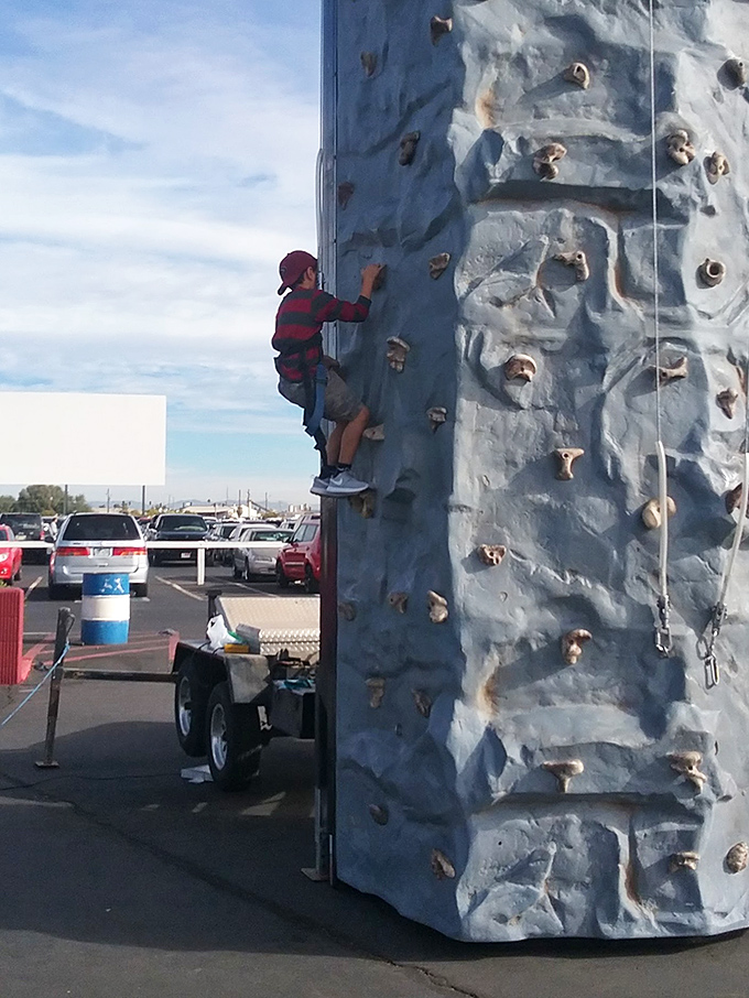 Kids scale this climbing wall like tiny Spider-Men, burning energy before the main event begins.