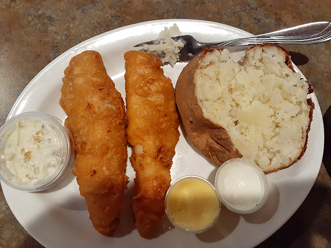 Golden-battered walleye that shatters with each bite, paired with a baked potato so fluffy it could double as a pillow.