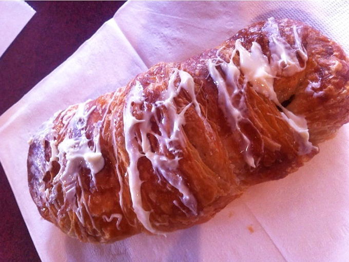 Layers upon glorious layers of buttery pastry, glistening with icing that's melted just enough to make you consider licking the paper. Resistance is futile.