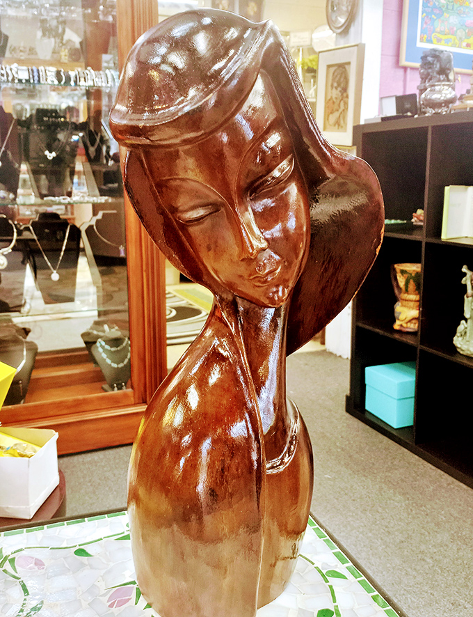 This elegant wood carving seems to be contemplating life's mysteries&mdash;or perhaps just judging your shopping choices with serene dignity. 