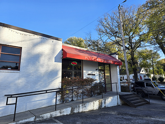 That red awning signals serious Italian business - where wood-fired ovens create pure pizza poetry. 