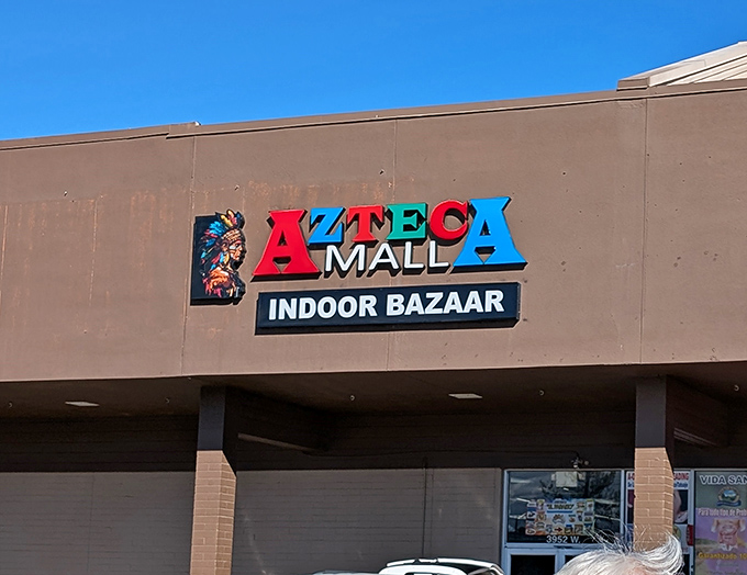 The colorful Azteca Mall sign promises an indoor adventure where cultures blend and bargains await discovery.