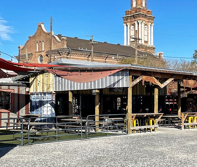 Central City BBQ's rustic wooden exterior feels like it's been smoking meat forever, with that historic church backdrop adding extra New Orleans character.