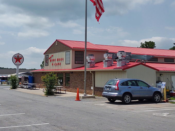 The red-roofed building sits ready to welcome shoppers seeking everything from antiques to everyday essentials.