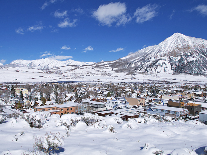 This cozy mountain town sparkles in twilight like scattered diamonds against the snowy Colorado landscape.