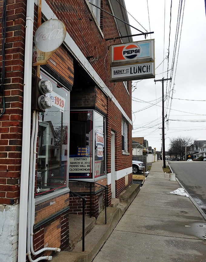 Brick walls and Pepsi signs create the perfect backdrop for serious hot dog business conversations.