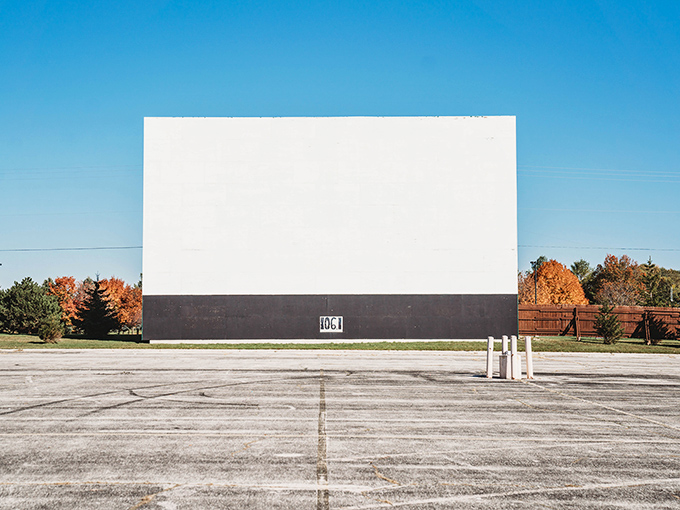 Movie screen meets autumn canvas! Chilton's pristine white monolith stands tall against fall's fiery palette, waiting for darkness to bring stories alive.