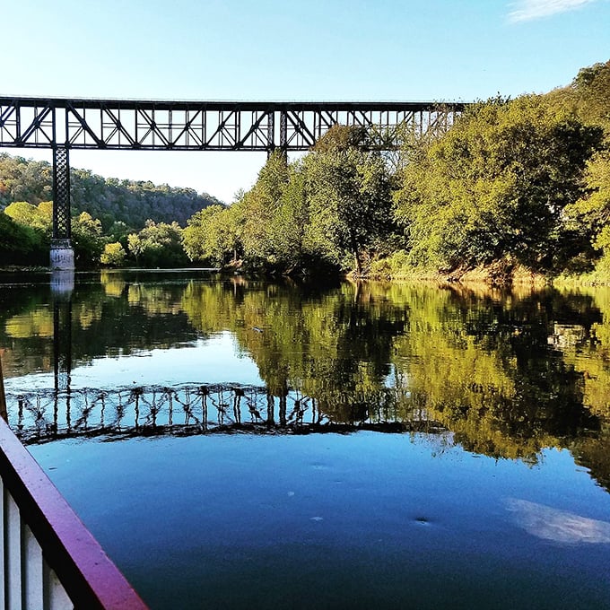 Harrodsburg's High Bridge spans the Kentucky River like a postcard from another era, reflecting perfectly in the still waters below.