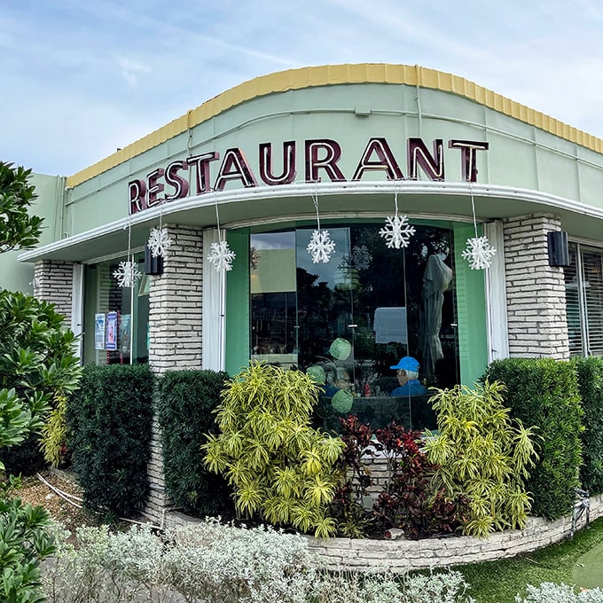 Mint-green mid-century magic! This curved-roof beauty has been feeding Palm Beach locals since Elvis was king.