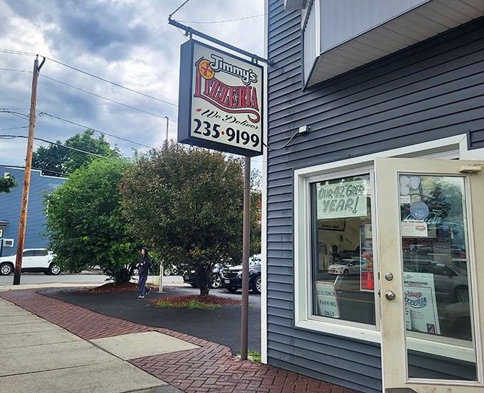 Jimmy's modest blue siding hides pizza treasures within. Like finding a vintage record store, the unassuming exterior makes the discovery even sweeter.