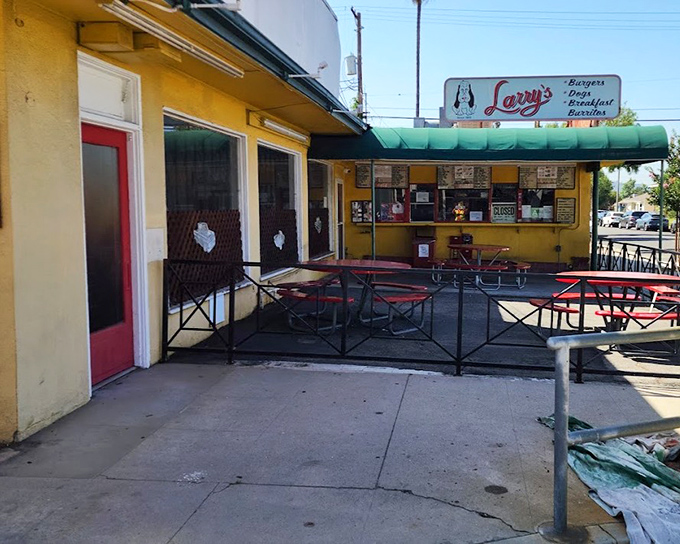 Yellow buildings and red umbrellas mean one thing: serious chili dog territory where locals gather for perfection.