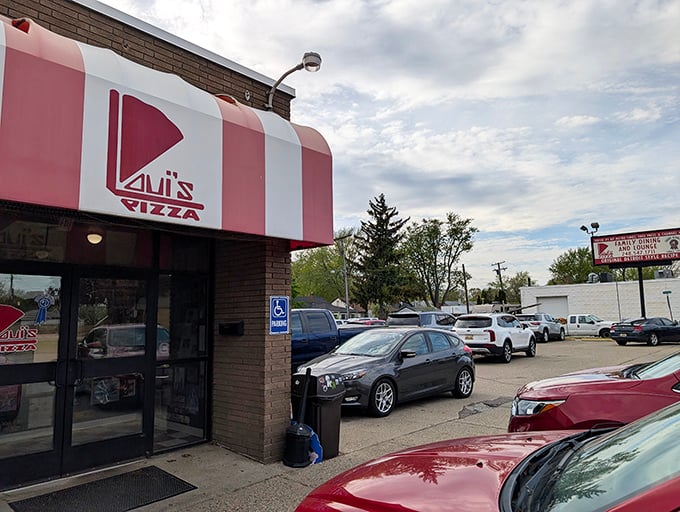 Loui's classic red and white awning promises the Detroit-style pizza experience that locals treasure.