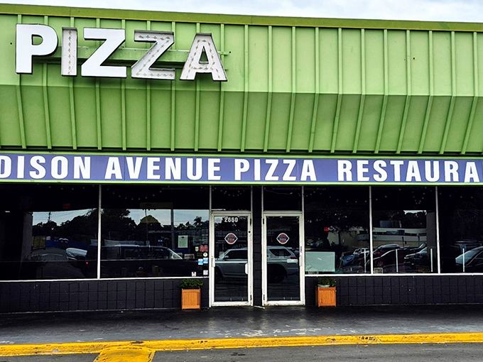 That lime green roof is like a neon sign screaming "GREAT PIZZA HERE!" Madison Avenue Pizza proves that sometimes the most unassuming buildings hide the most extraordinary flavors.