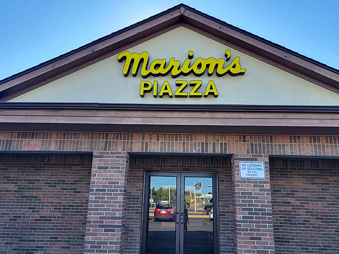 Marion's cheerful yellow sign beckons like a lighthouse for Dayton's legendary pizza pilgrims.