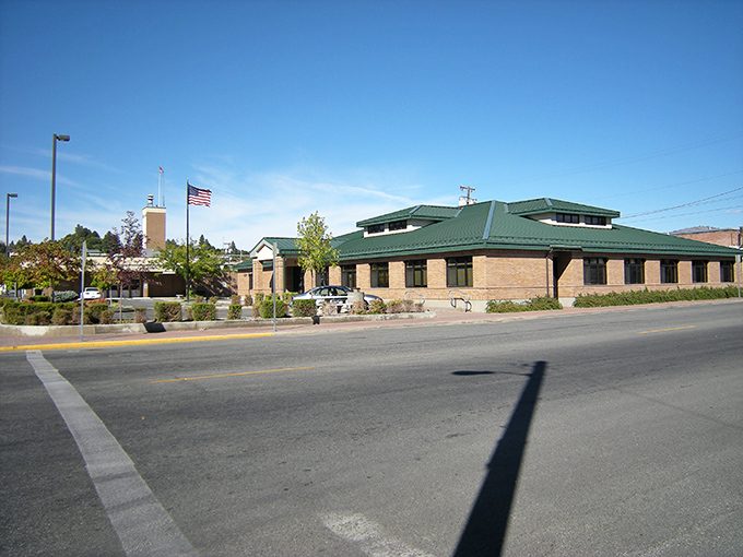 Omak's civic pride shines under impossibly blue skies! This building hosts more small-town drama than "Parks and Recreation."