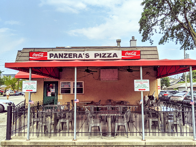 That red awning beckons like a pizza lighthouse, guiding hungry souls to cheesy salvation below.