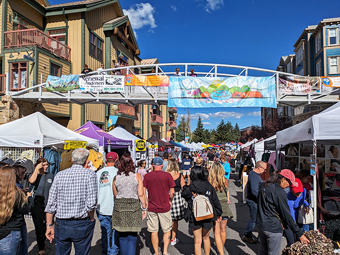 Colorful banners dance overhead while families create weekend memories one booth at a time below.
