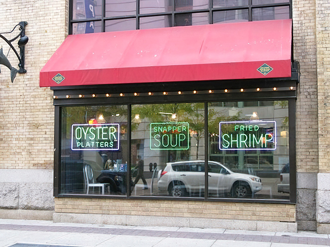 Market counters become stages where oyster shuckers perform their daily ballet of blade and shell.
