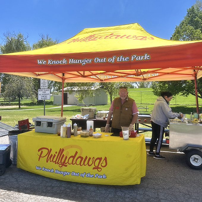 Philly Dawgs' bright yellow tent stands out like a beacon of hope for the hungry. "Knocking hunger out of the park" is no empty promise!