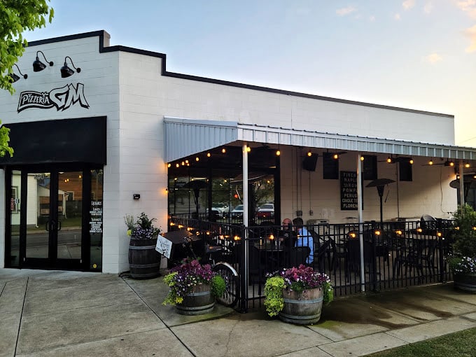 String lights and white brick create the perfect backdrop for serious pizza artistry.