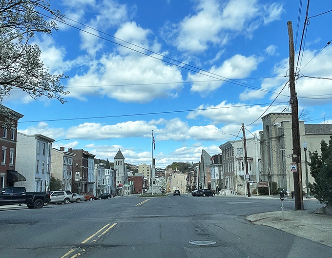 A calm day in downtown Pottsville, where historic buildings line the streets beneath a sky painted with drifting clouds.