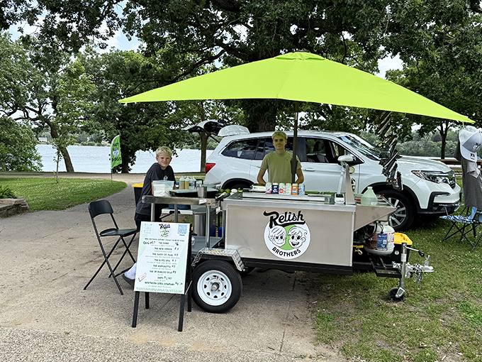 Relish Brothers' mobile setup brings the hot dog party to you. That bright green umbrella is like a beacon for hungry park-goers.
