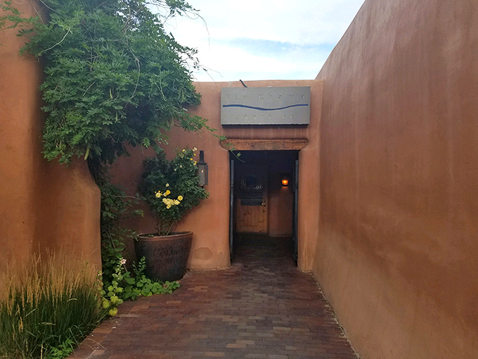 That adobe courtyard entrance whispers "come discover something special" in the most Santa Fe way possible and delicious.