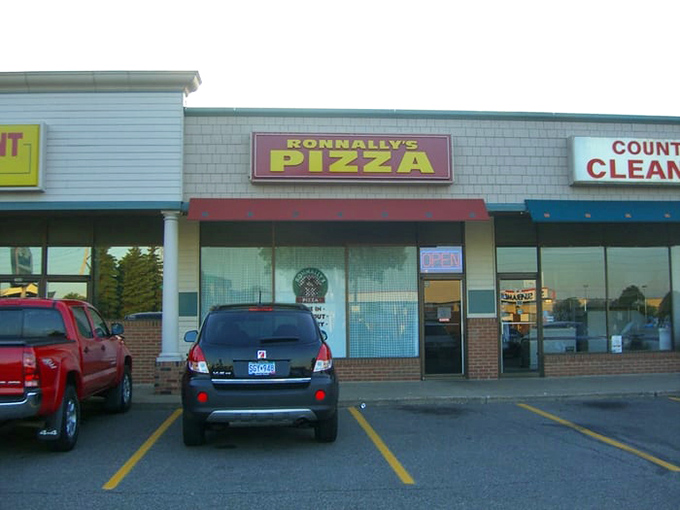 Ronnally's modest storefront in the strip mall &ndash; proof that extraordinary pizza often hides in ordinary places.