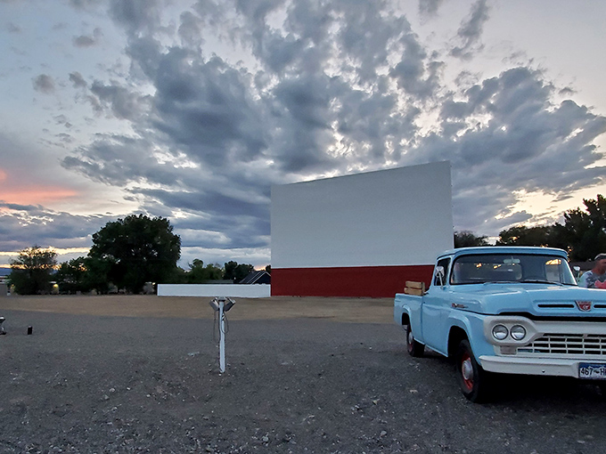As twilight settles over Montrose, the Star Drive-In&rsquo;s screen stands ready for showtime, with a vintage blue truck adding a touch of nostalgia to the scene.