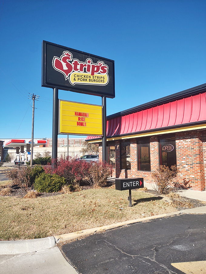 Strip's bright signage stands out like a beacon for hungry travelers. Where chicken strips and Hawaiian rice bowls create unexpected harmony.