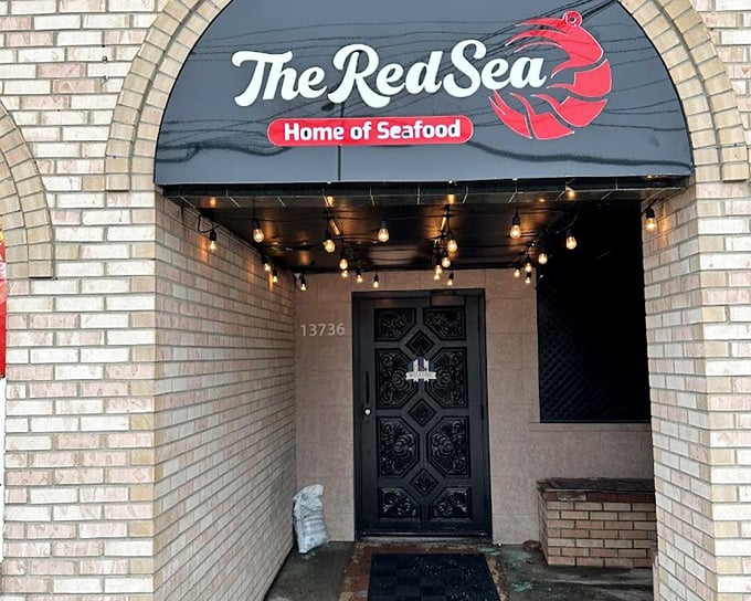 The Red Sea's welcoming brick entrance and glowing sign are like a lighthouse for seafood lovers in Dearborn.