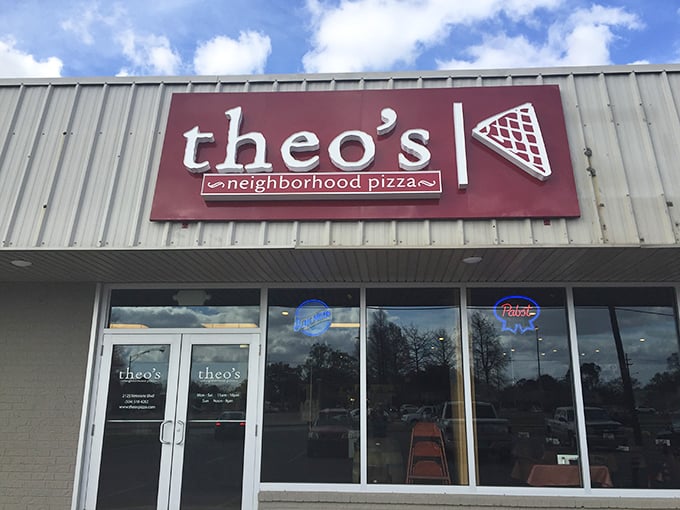 Theo's bold red sign stands out like a pizza lover's North Star, guiding hungry travelers to thin-crust nirvana.