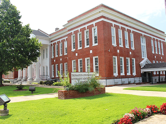 Bright flowers and classic red brick greet visitors at the Thomaston-Upson Government Complex, showcasing small-town pride and Southern charm.