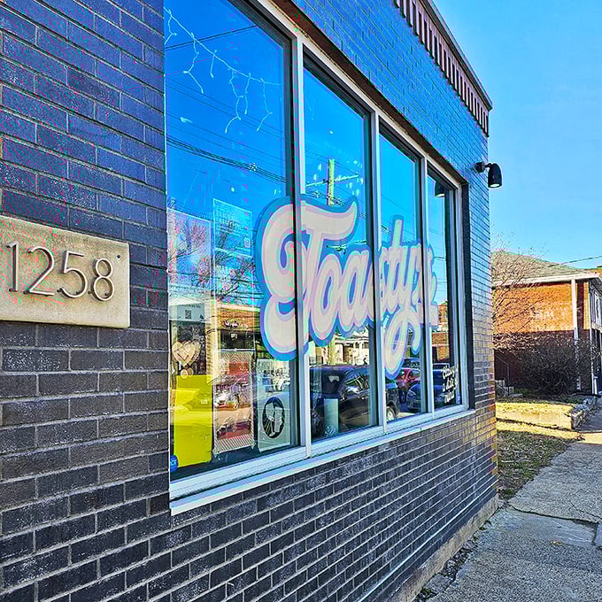 That friendly brick storefront with blue script lettering whispers "neighborhood treasure" to those who know.