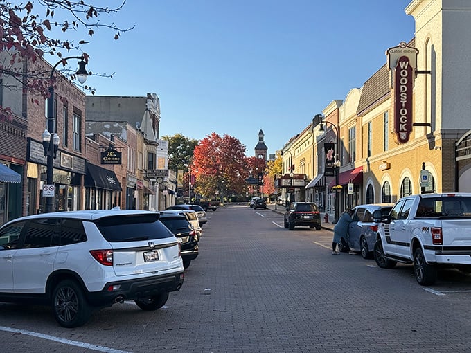 Showtime in small-town America! Woodstock's vertical theater sign stands tall against autumn's fiery display like the town's own Broadway marquee.