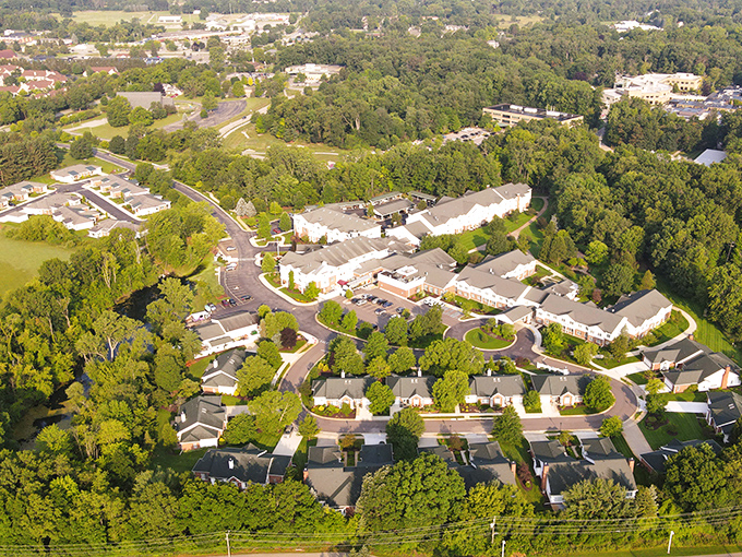 Silver Maples of Chelsea's aerial view nestles among Michigan's trees, offering affordable retirement living with nature's beauty right outside your door.