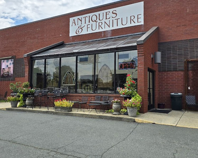 That charming brick storefront with colorful planters welcomes shoppers like an old friend inviting you in for coffee.