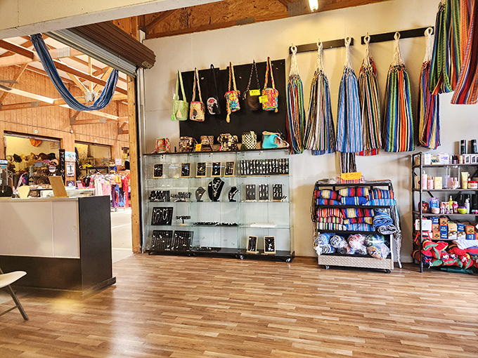 Handcrafted bags hang like colorful flags inside Barnyard Flea Market, showcasing the artisan touch among rows of practical finds.