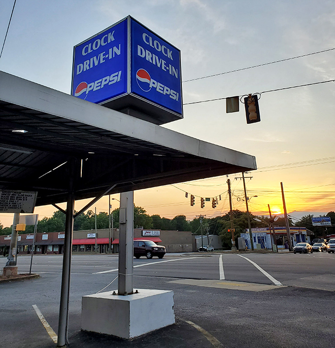 Sunset at the Clock Drive-In&mdash;where the golden hour meets golden onion rings in perfect harmony.