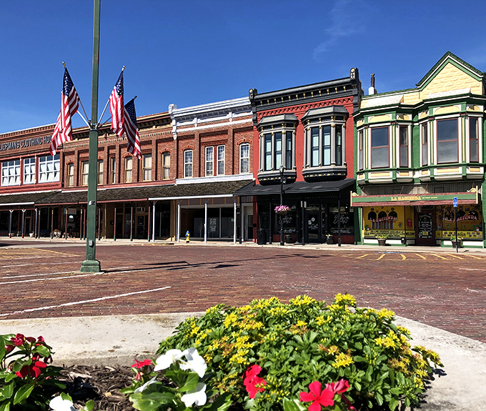 Architectural eye candy! Fort Scott's rainbow row of storefronts stands proudly behind blooming flower beds—like a Victorian-era Instagram waiting to happen.