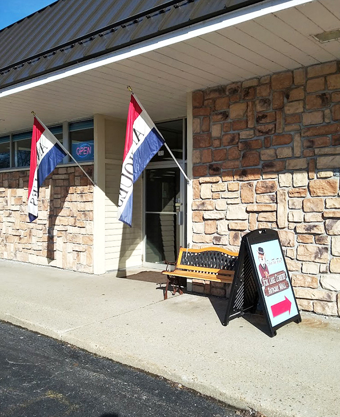 Open flags wave a friendly hello at Fox Lake Country Antiques, where the stone building houses decades of memories waiting to be discovered.