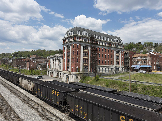 CSX coal cars deliver their black gold beneath Grafton's brick sentinel, a building that's seen more history than Ken Burns documentaries.