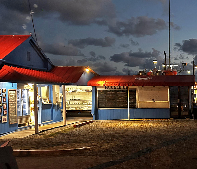 As night falls, Hooked Up glows like a seafood lighthouse, beckoning hungry travelers with promises of oceanic treasures served without pretension.