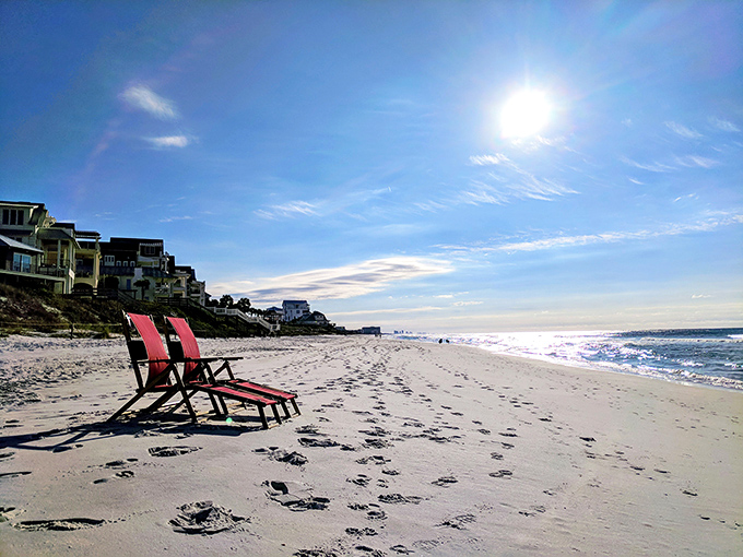 Red beach chairs standing sentinel on Inlet Beach &ndash; waiting for you to claim your throne overlooking the emerald kingdom.