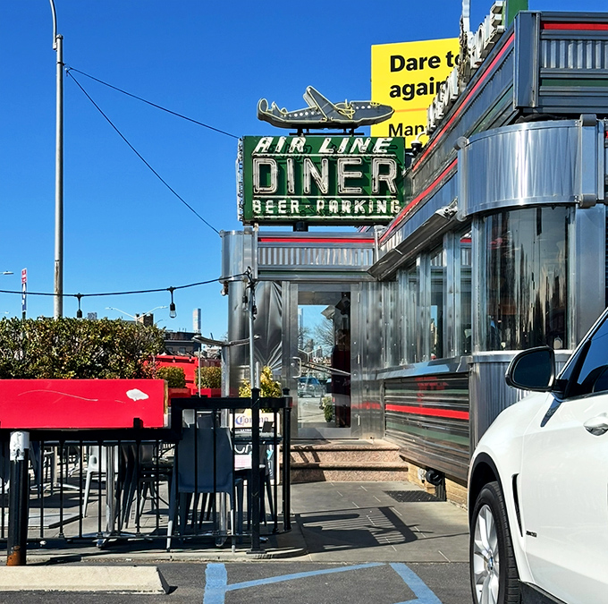 Classic diner architecture meets Queens charm where planes and pancakes share the sky.