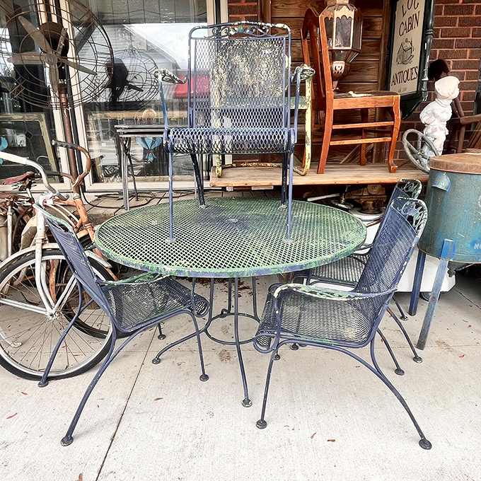 Vintage bicycles and weathered furniture create an irresistible outdoor preview of indoor treasures.
