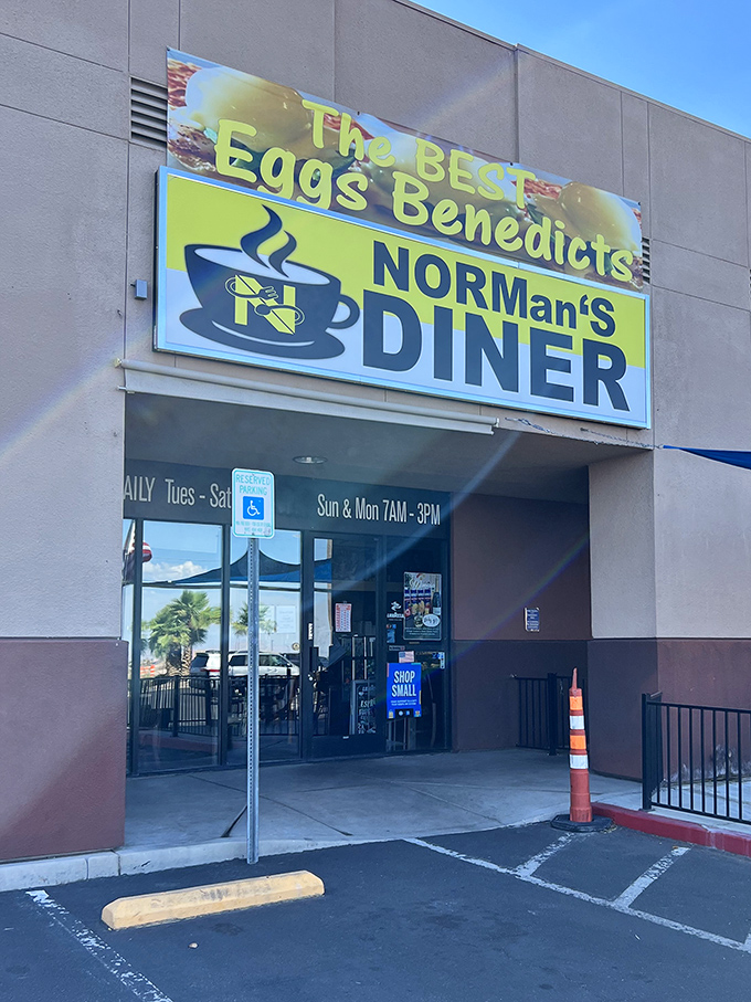 Morning light catches NORMan's DINER sign, where early birds flock for hollandaise sauce that should have its own fan club.