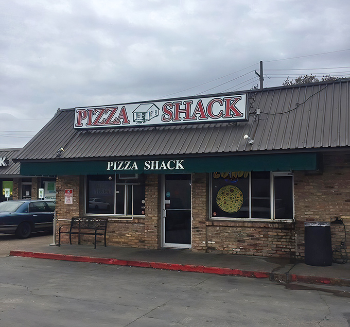 The classic brick and metal awning of Pizza Shack whispers of decades of pizza perfection. Some traditions don't need updating.